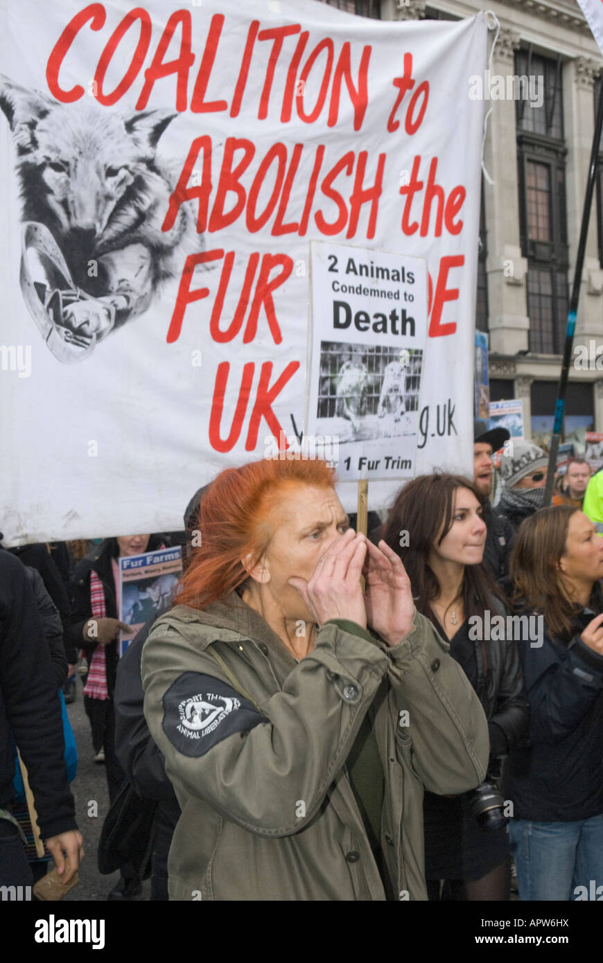 Woman shouting in front of 'Coalition to Abolish the Fur Trade' banner ...