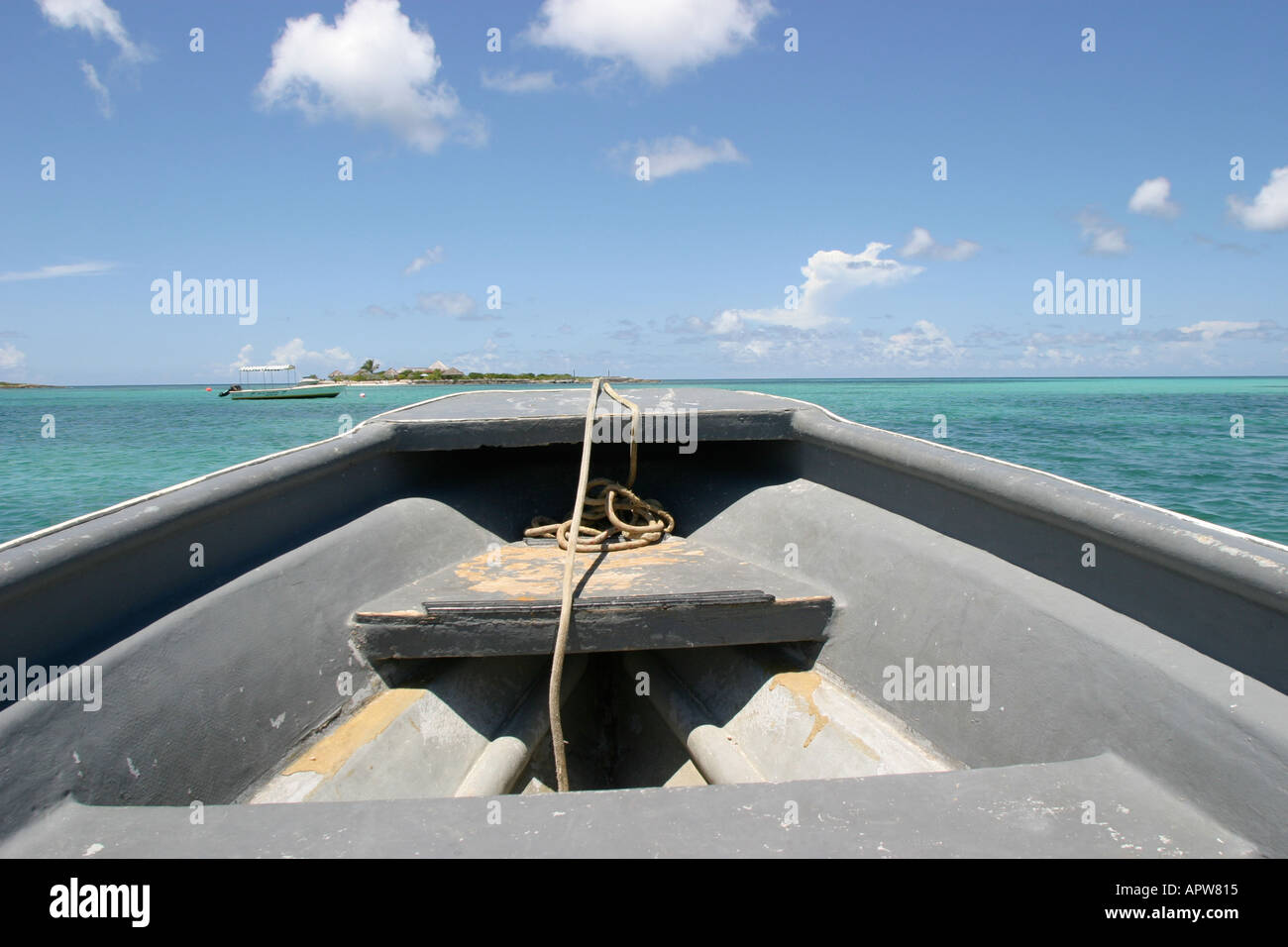 A boat sailing to a tropical Island in the Caribbean viewed from the ...
