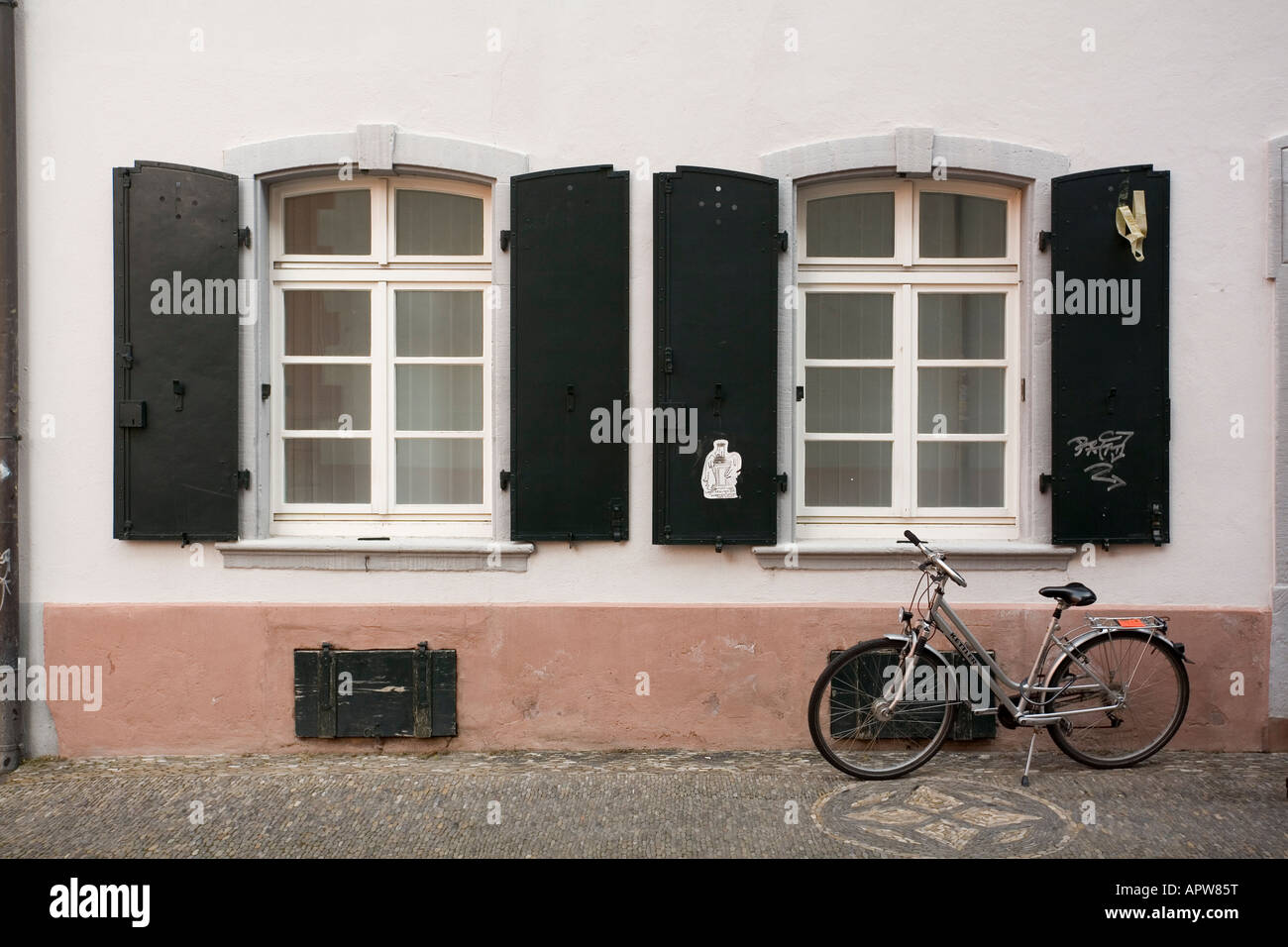 Bicycle and windows with shutters, Germany Stock Photo - Alamy