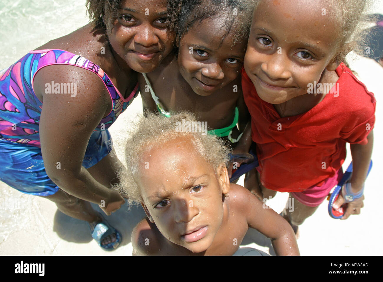 Black childeren playing on the beach in Island Harbour off the island ...