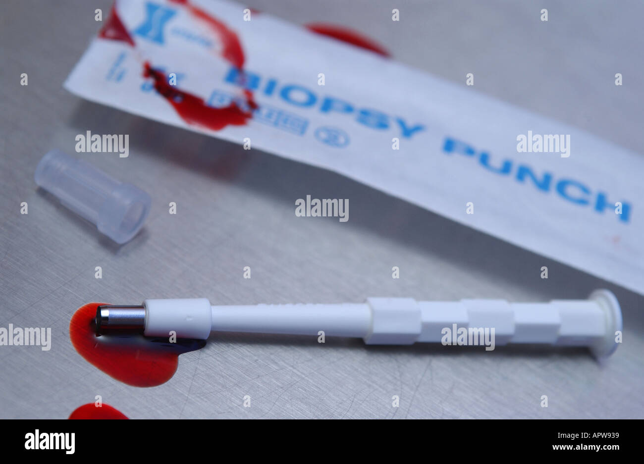used surgical instrument biopsy punch with blood on it Stock Photo - Alamy
