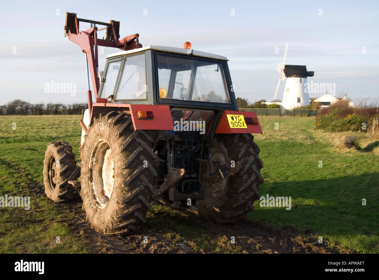 Tractor and windmill Stock Photo - Alamy
