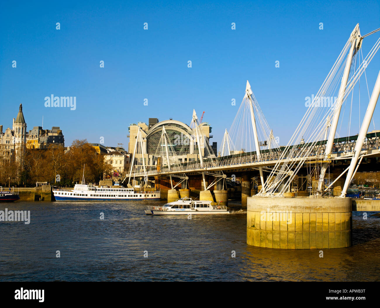 The Hungerford Footbridge Hispaniola and pleasure boat passing under ...