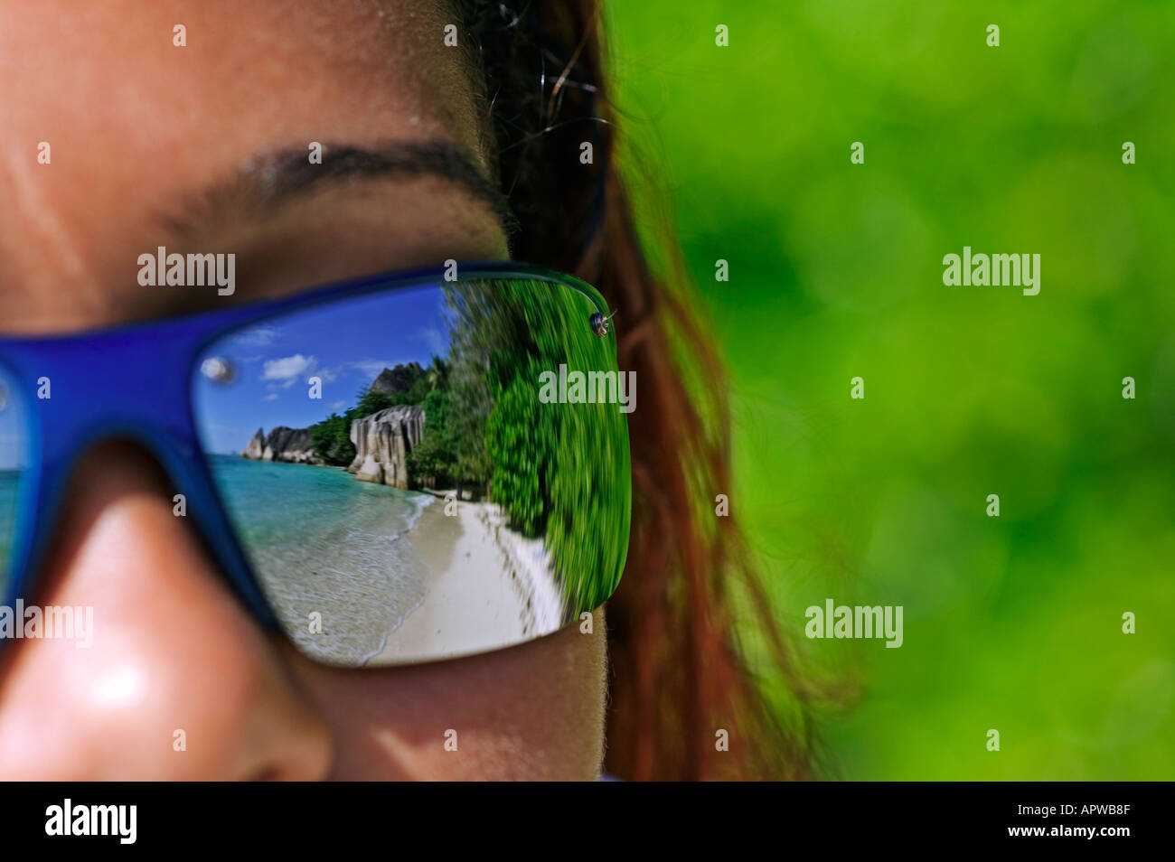 Reflection of beach scene in sunglasses Model released Anse Source d ...
