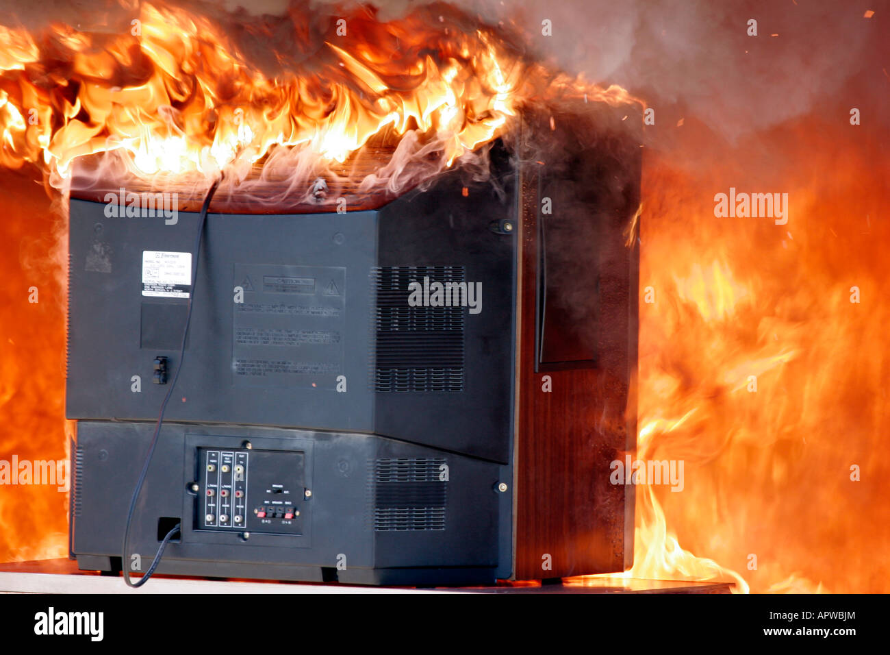 A television or TV on fire at an fire safety demonstration that shows ...