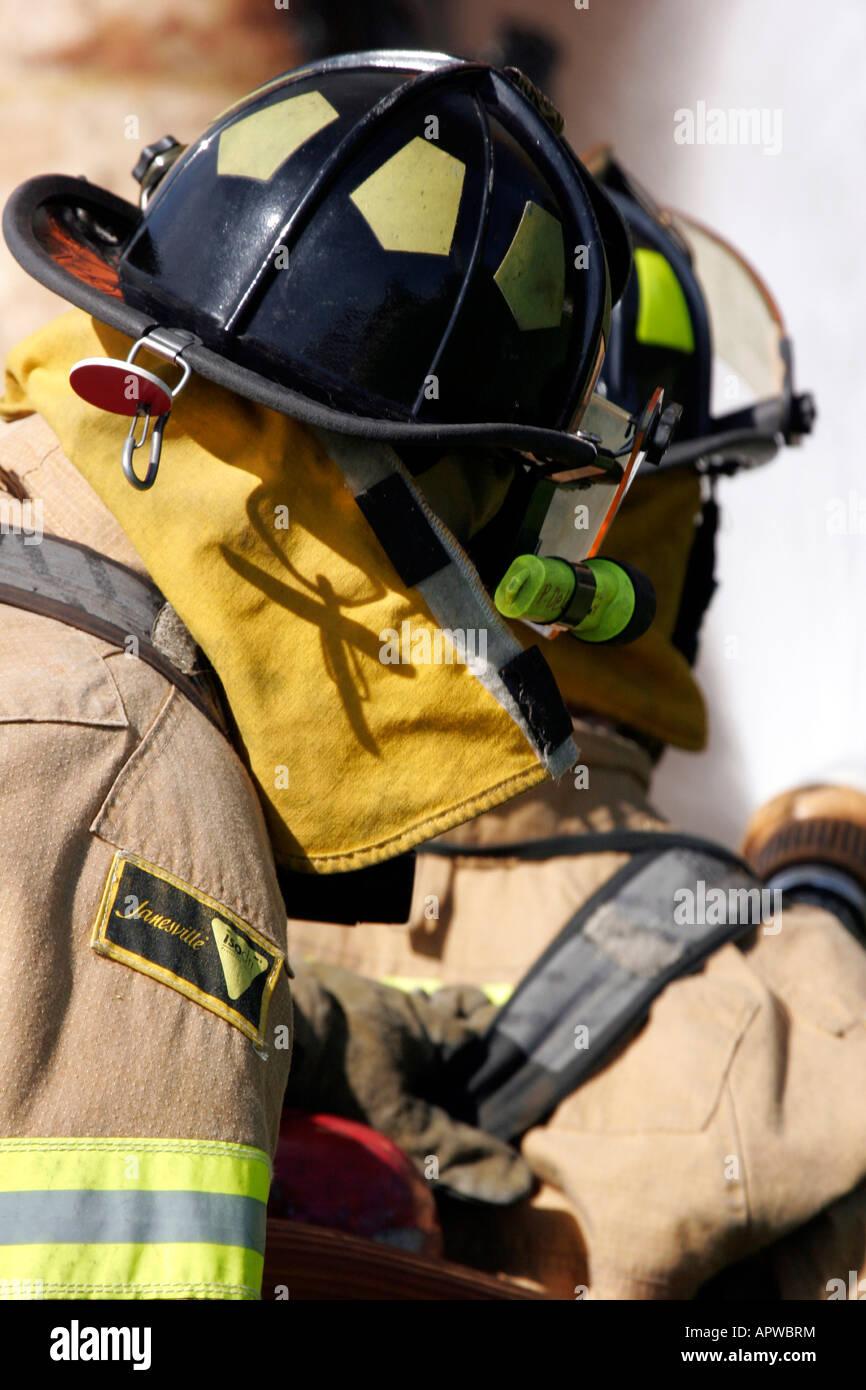 Two firefighters extinguishing a structure fire Stock Photo - Alamy