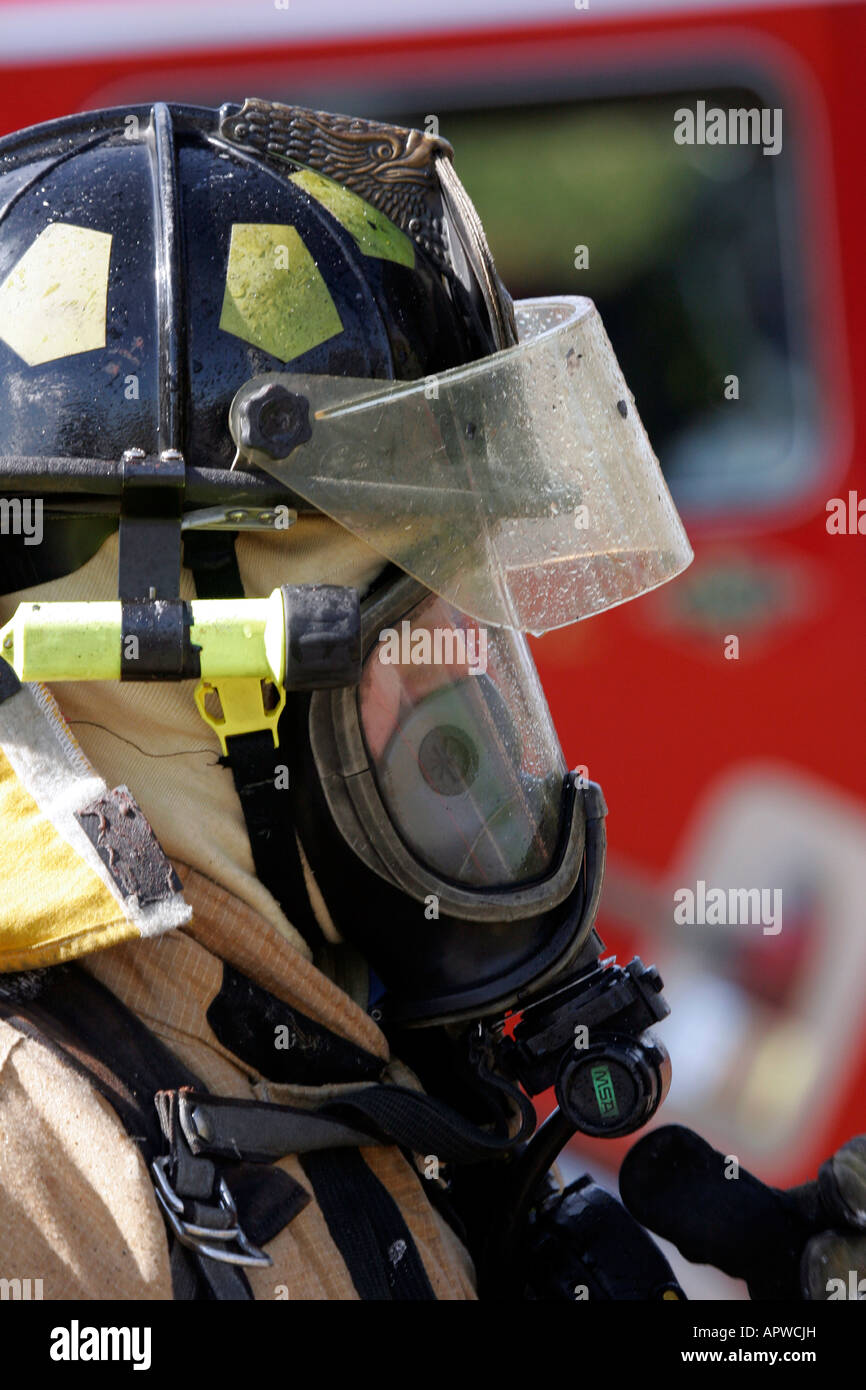 A firefighter standing in front of the fire engine Stock Photo - Alamy