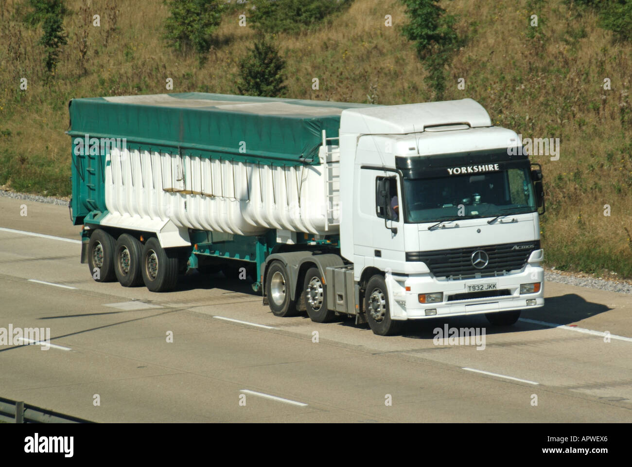 Bulk carrier articulated trailer and Mercedes Benz hgv truck driving ...