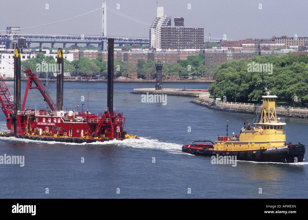 Tugboat towing construction barge or scow on the East River, New York ...