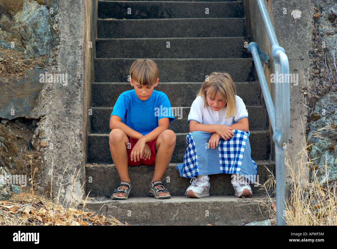brother and sister sit on the steps Stock Photo - Alamy