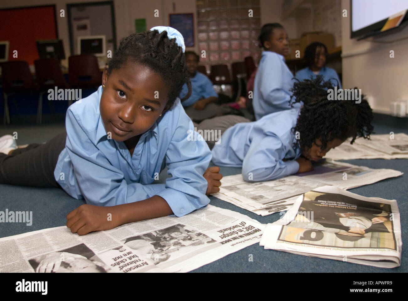 Primary school children attending newspaper group at after school club ... Primary school children attending newspaper group at after school club ...