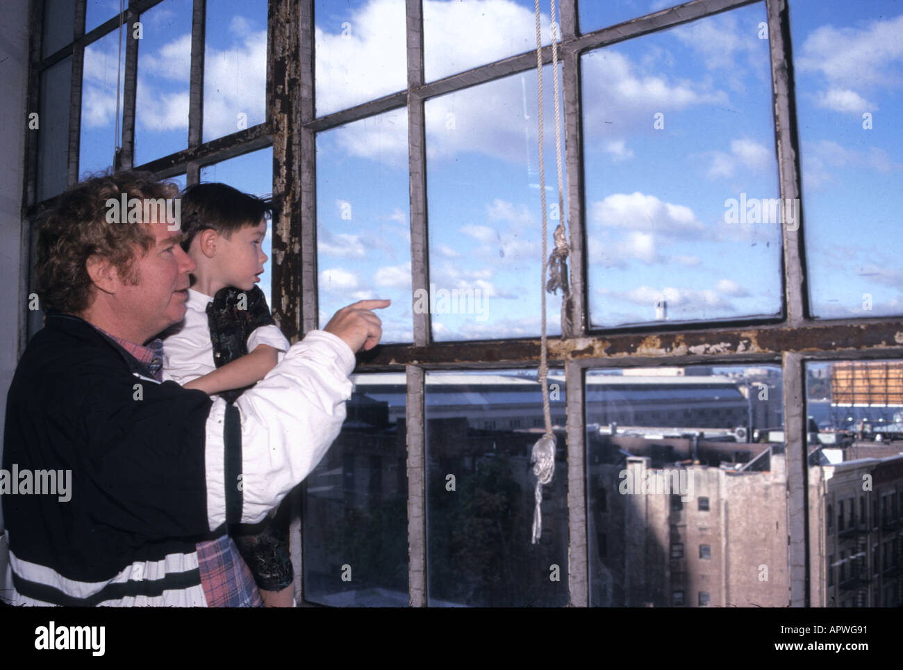 father and son looking out window Stock Photo - Alamy
