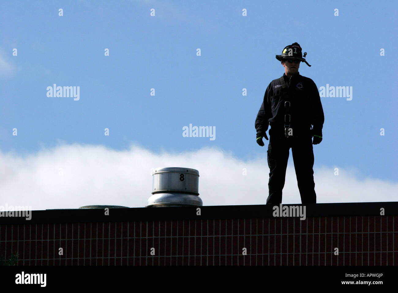 Firefighter on building roof hi-res stock photography and images - Alamy