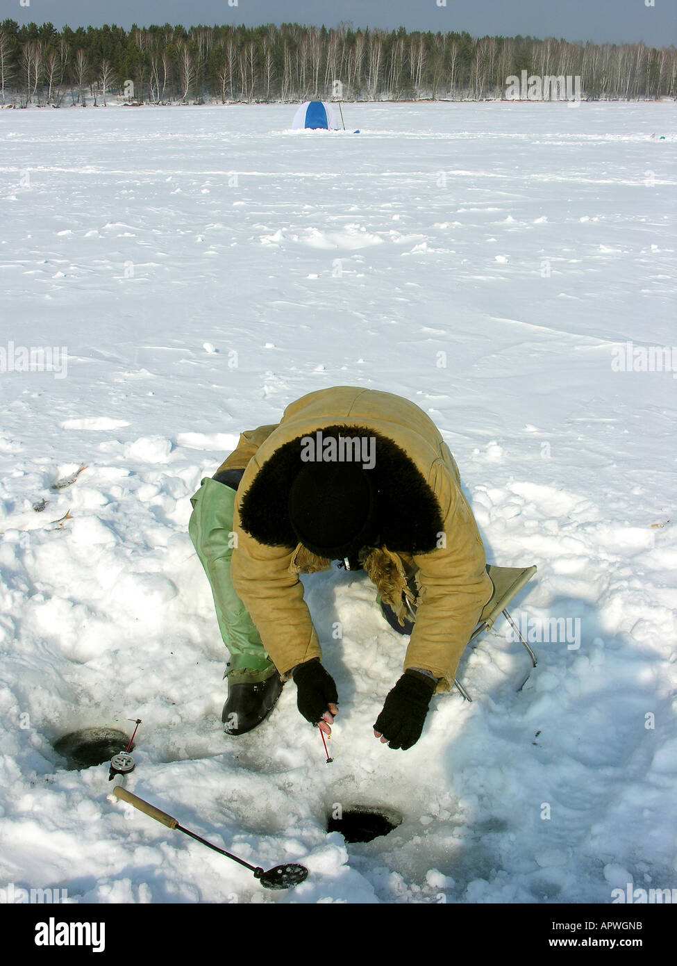 Ice fishing in Ural Mountains Russia Stock Photo - Alamy