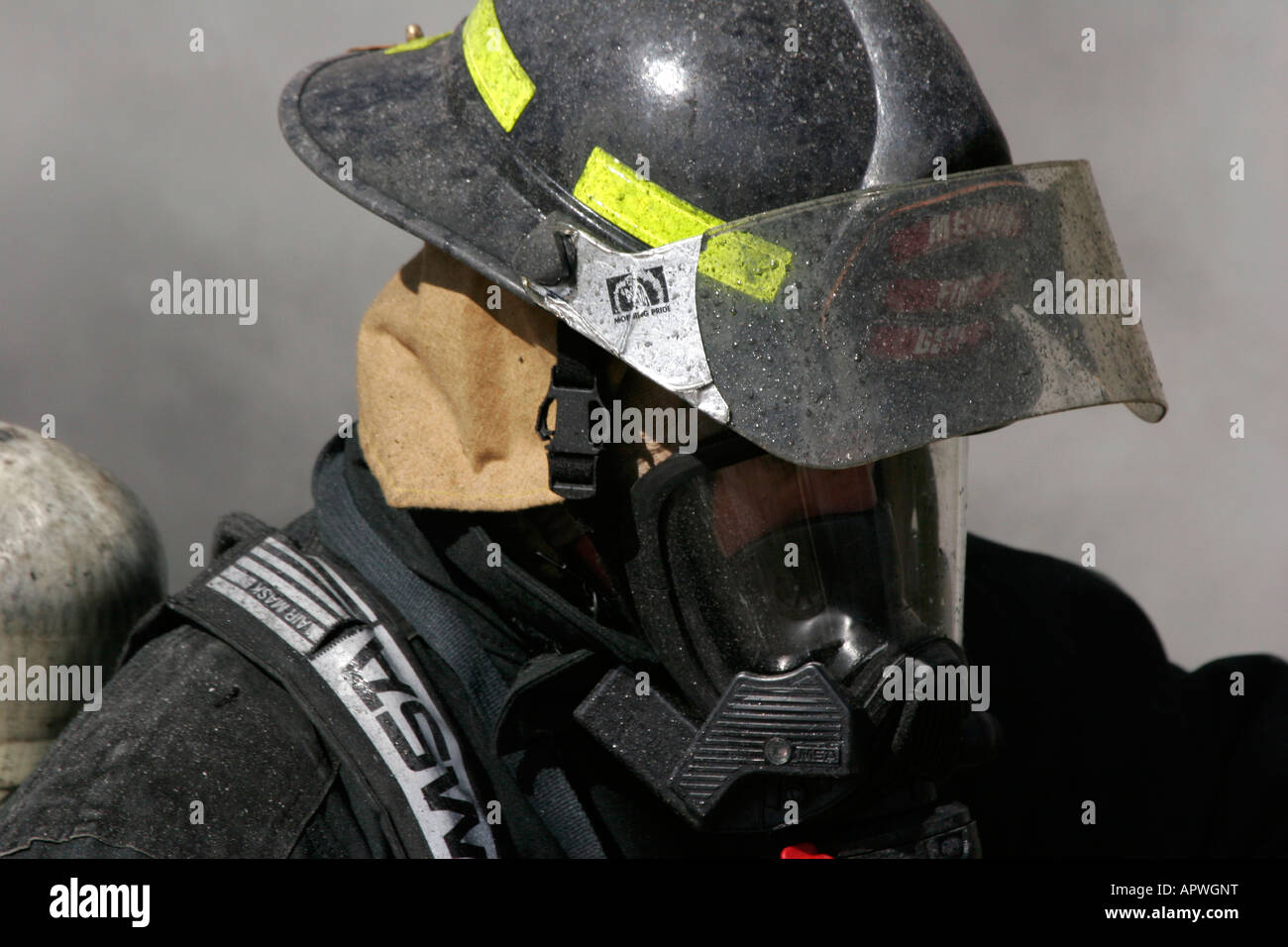 A firefighter suited up with his bunker equipment with a black helmet ...