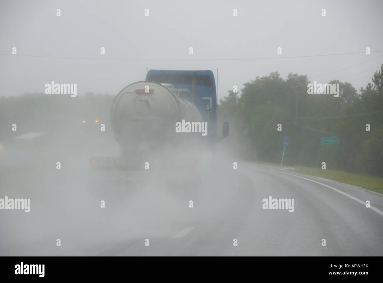 Bad weather rain and spray on highway dangerous driving conditions ...