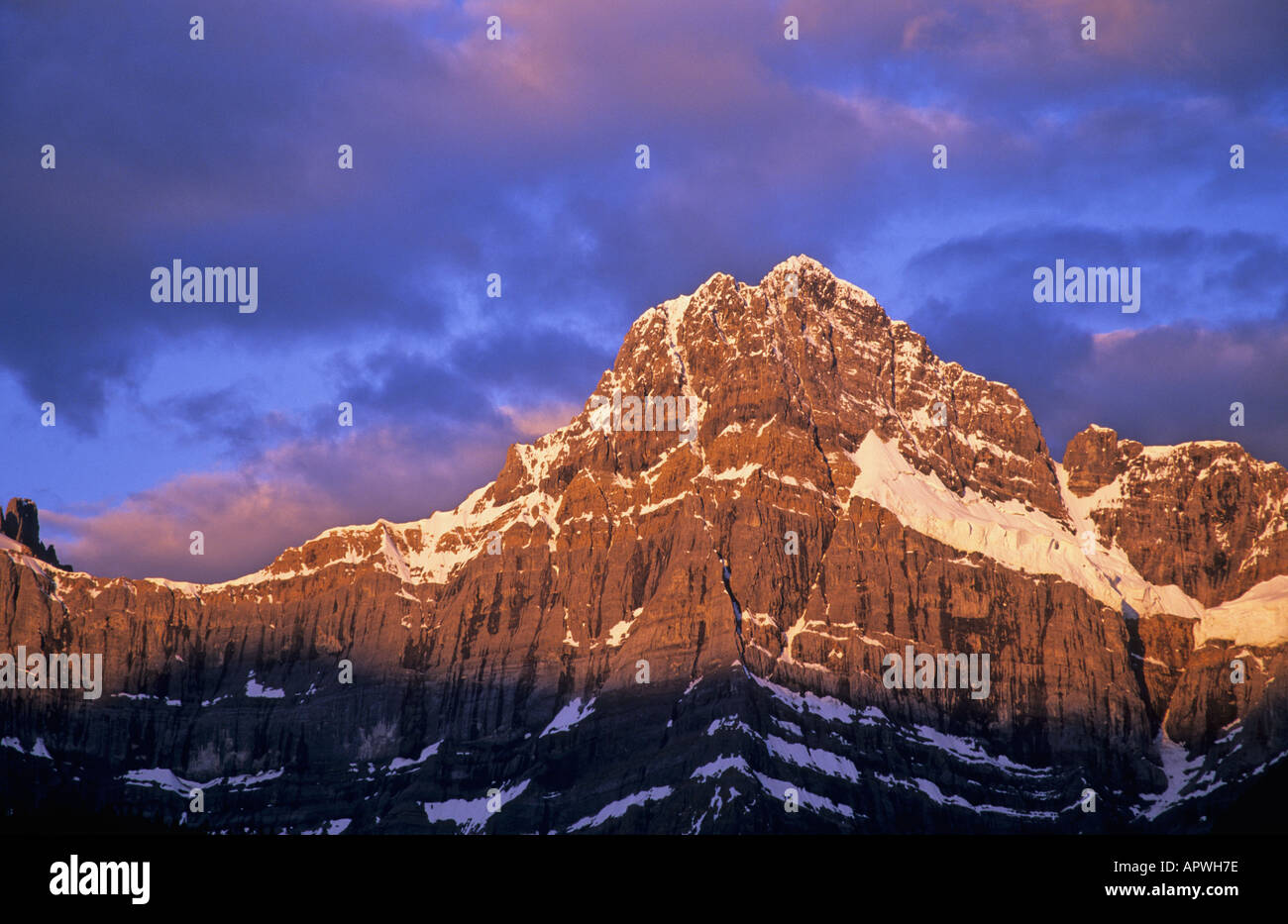 Alpenglow lights up a peak at sunrise Banff National Park Alberta ...