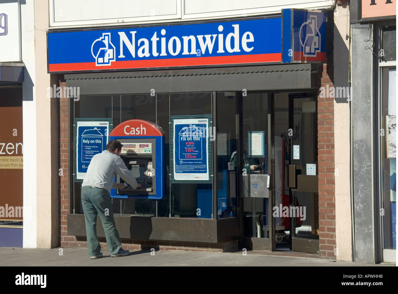 Branch high street premises of Nationwide building society with man ...