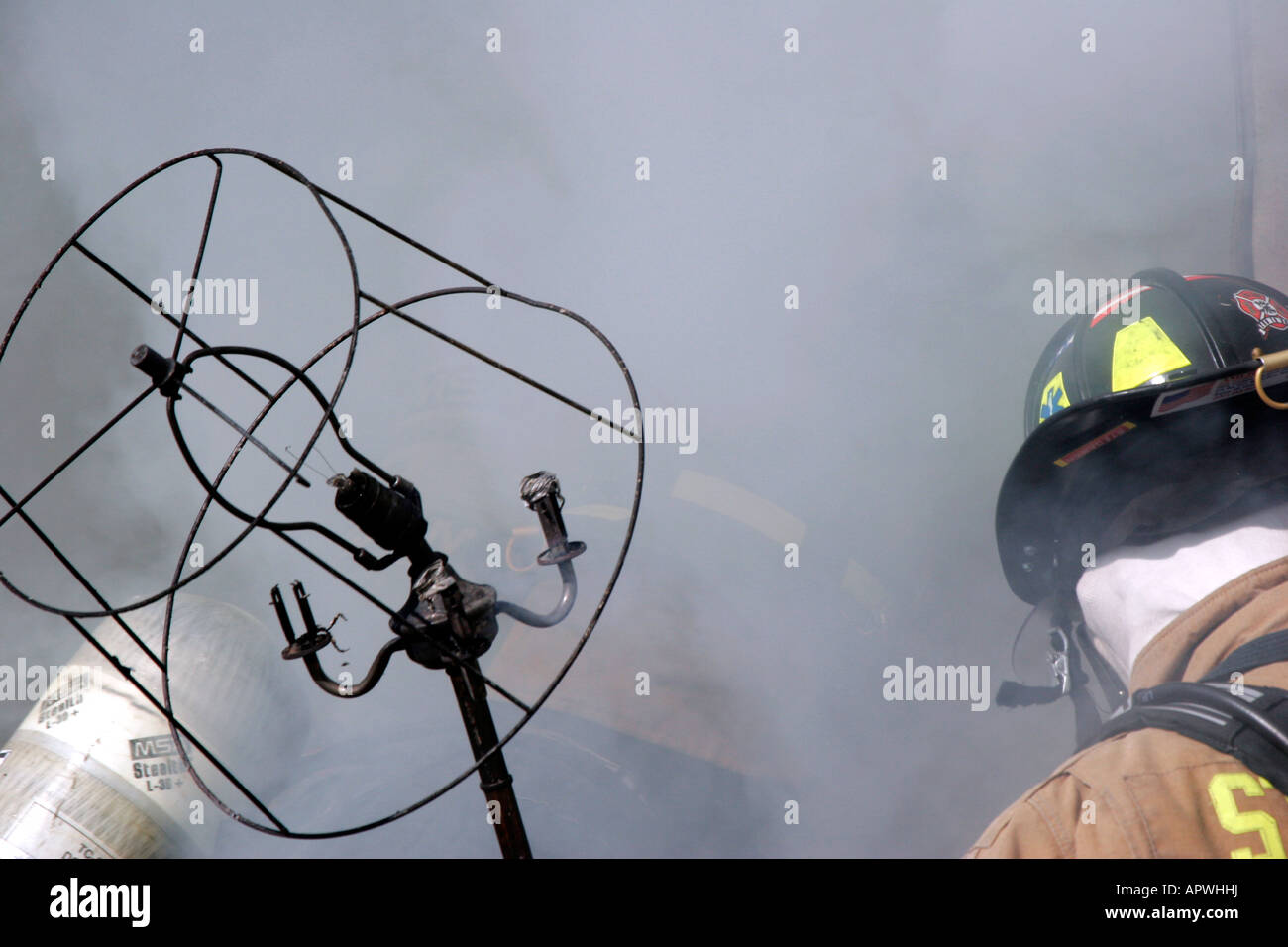 An American Firefighter removing a burnt lamp frame from the scene of ...