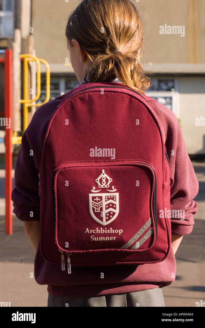 Primary schoolgirl wearing school logo backpack, London, UK Stock Photo ...