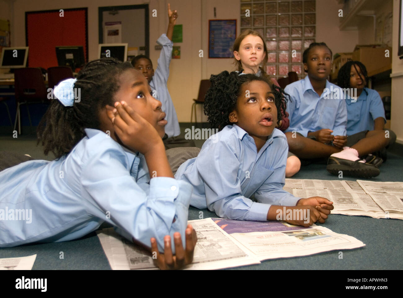 Primary school children attending newspaper group at after school club ... Primary school children attending newspaper group at after school club ...