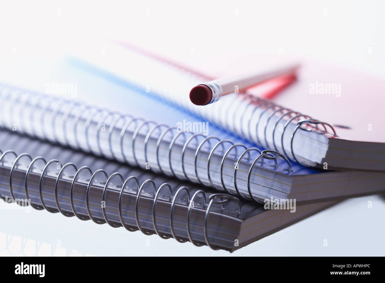 Stack of Spiral Notebooks with Pencil on top Stock Photo - Alamy
