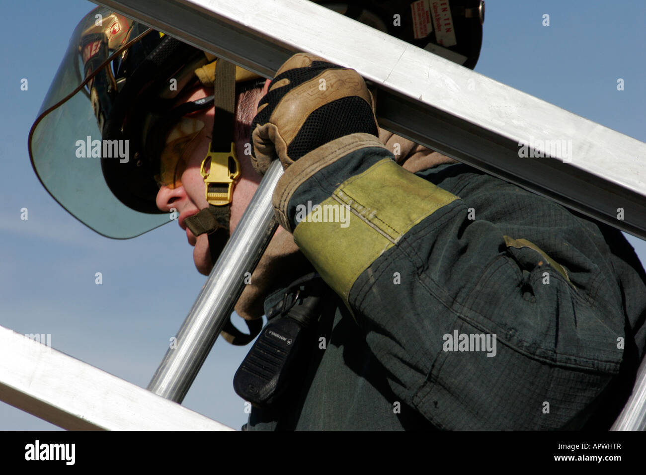 A firefighter carrying a metal ladder to the trench to do a trenching ...