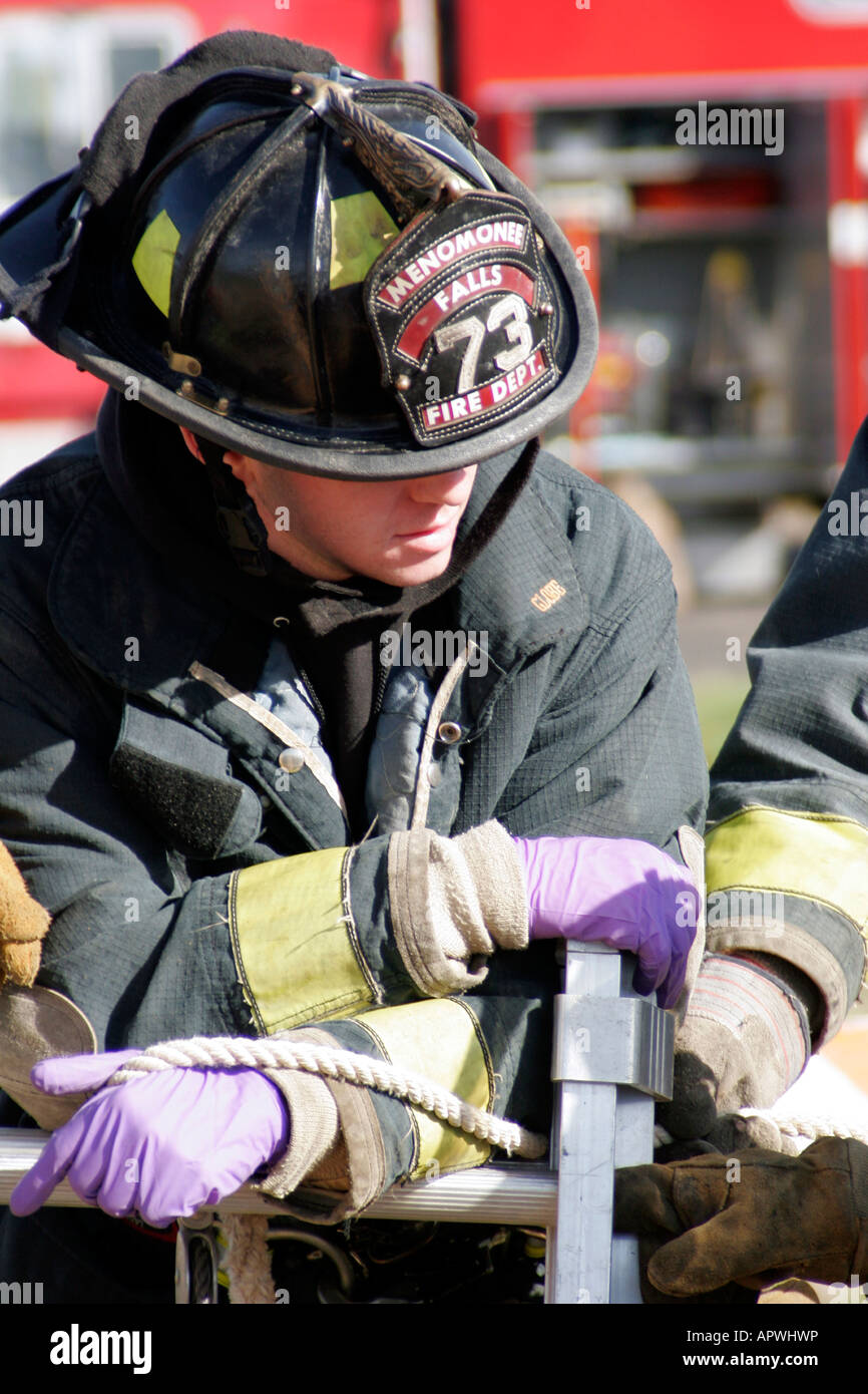 A firefighter holding a ladder during a trench rescue exercise Stock ...