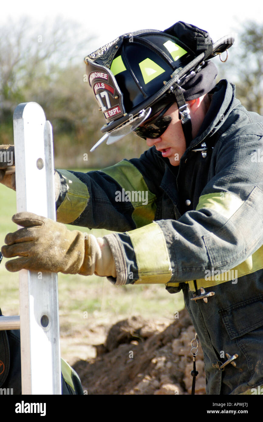 A firefighter holding a ladder during a trench rescue exercise Stock ...