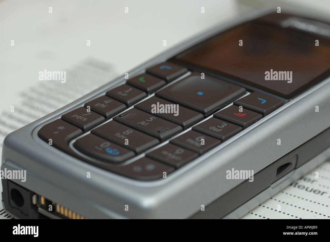 mobile phone on German business document Stock Photo - Alamy