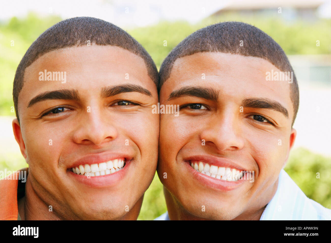 Close up of Hispanic twin brothers smiling Stock Photo - Alamy