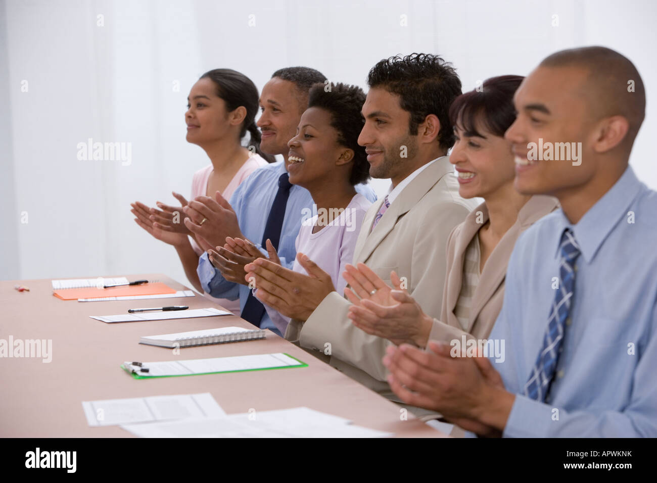 Multi-ethnic businesspeople clapping Stock Photo - Alamy