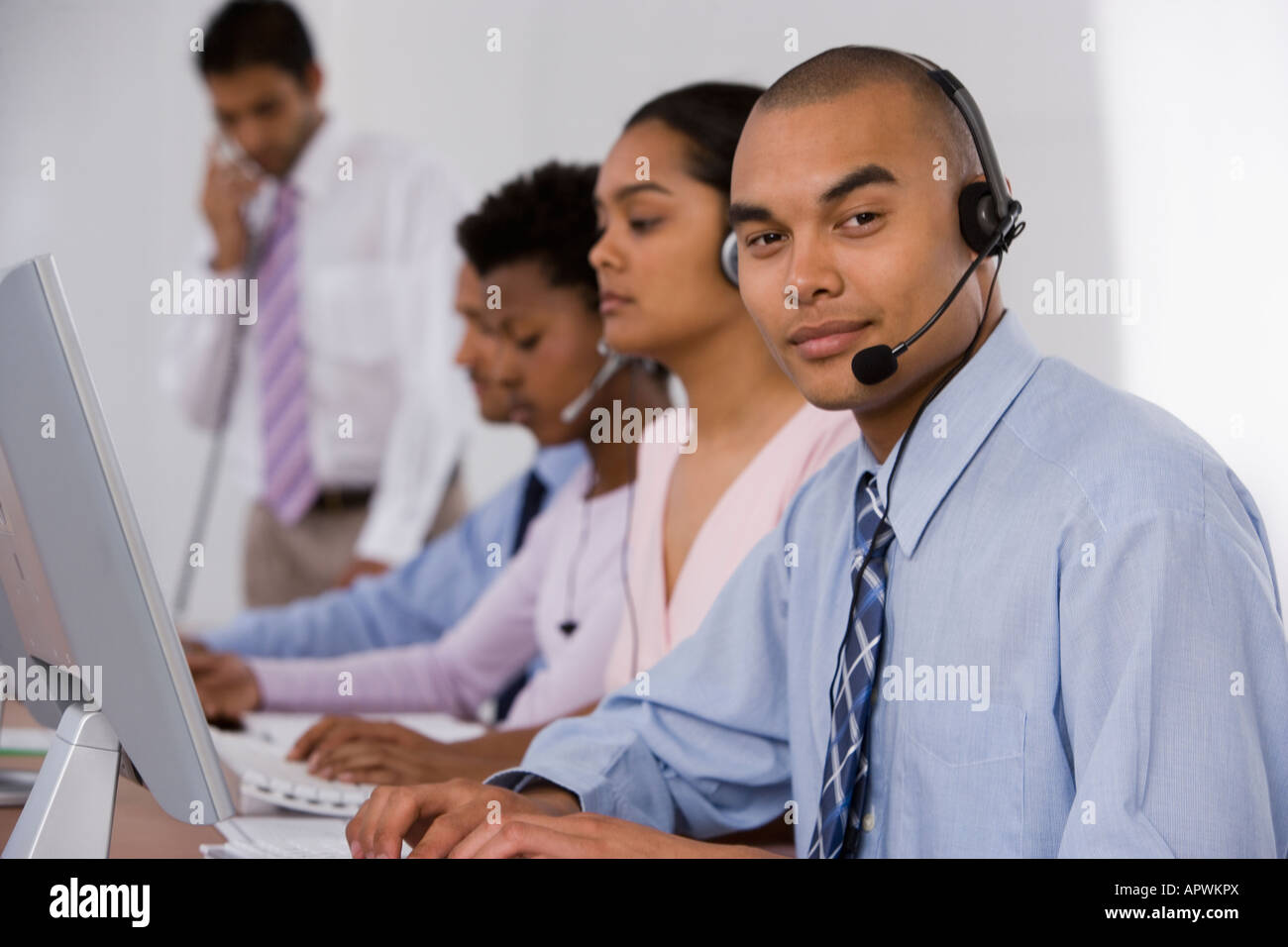 Multi-ethnic businesspeople working at computers Stock Photo - Alamy