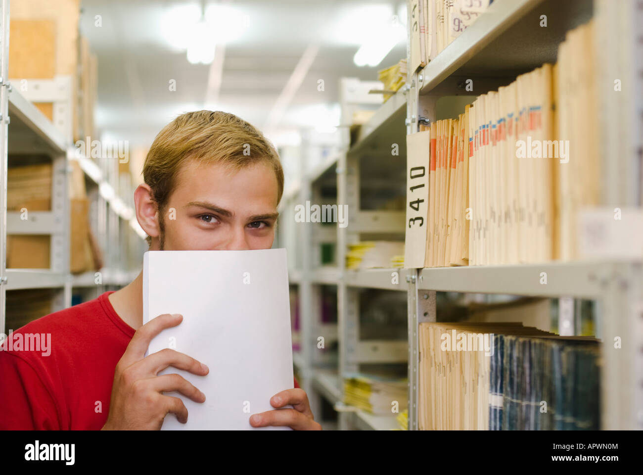 Boy hiding behind shelf hi-res stock photography and images - Alamy