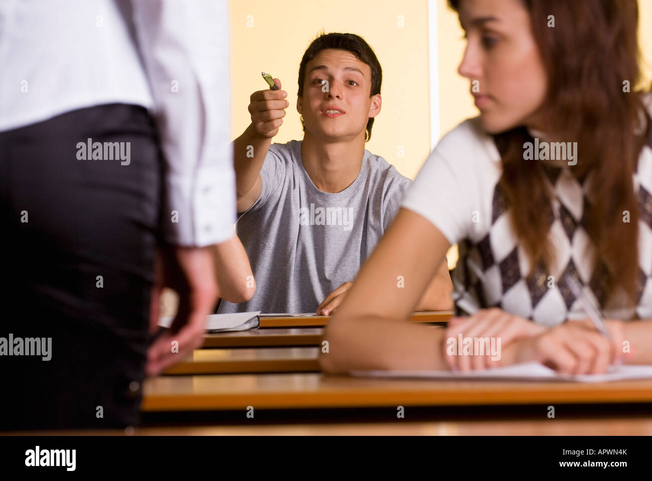 male student giving explanation to teacher during school seminar Stock ...