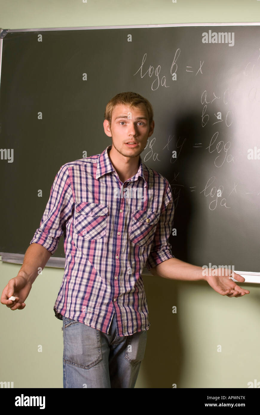 portrait of young student standing in front of blackboard Stock Photo ...