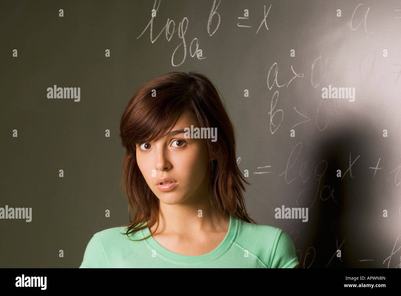 portrait of confused female student in front of blackboard Stock Photo ...