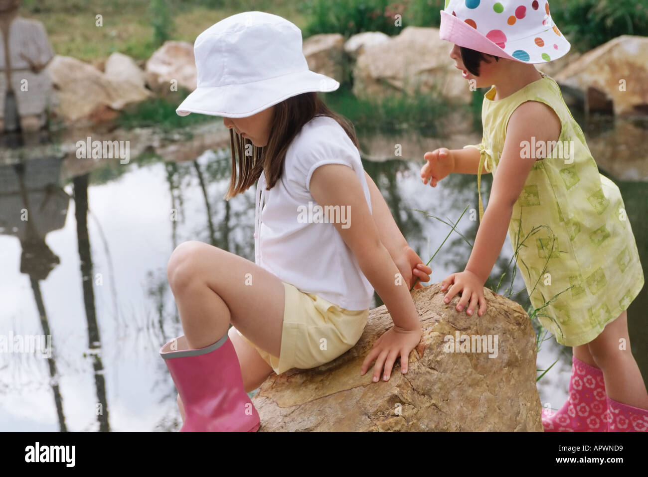 Girls by a pond Stock Photo - Alamy