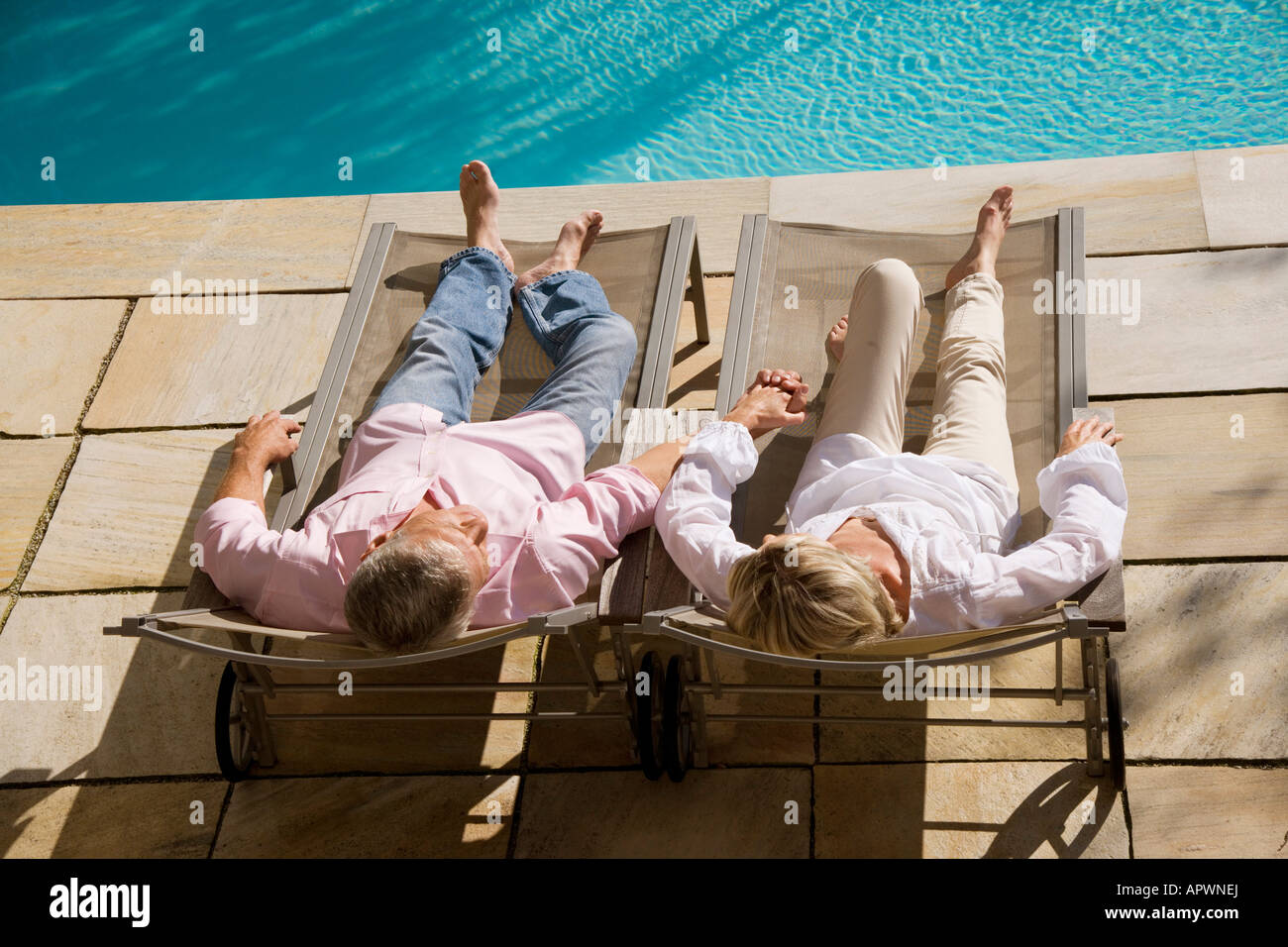 Senior couple near swimming pool hi-res stock photography and images ...