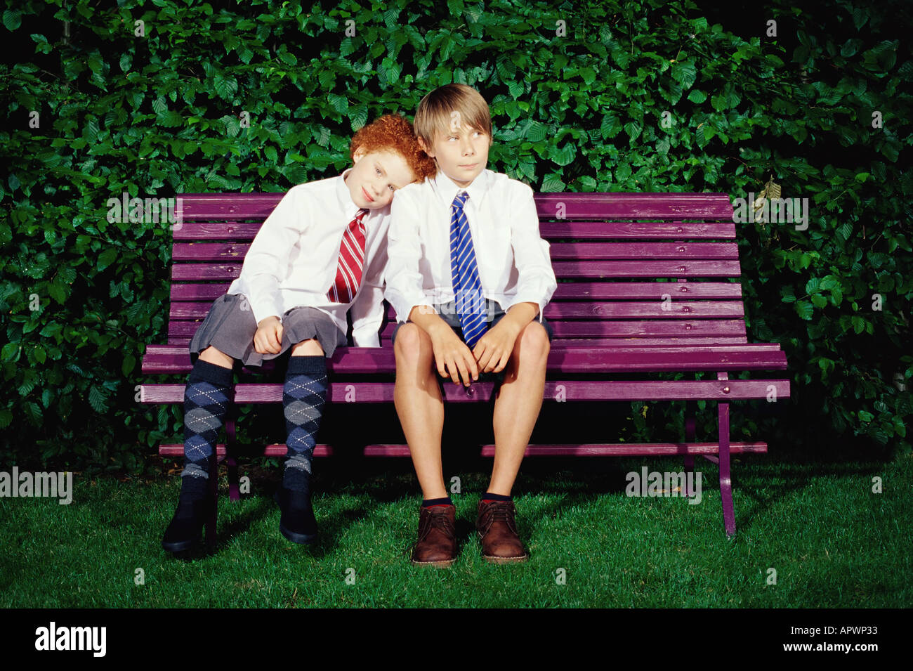 Friends sitting on a park bench Stock Photo - Alamy