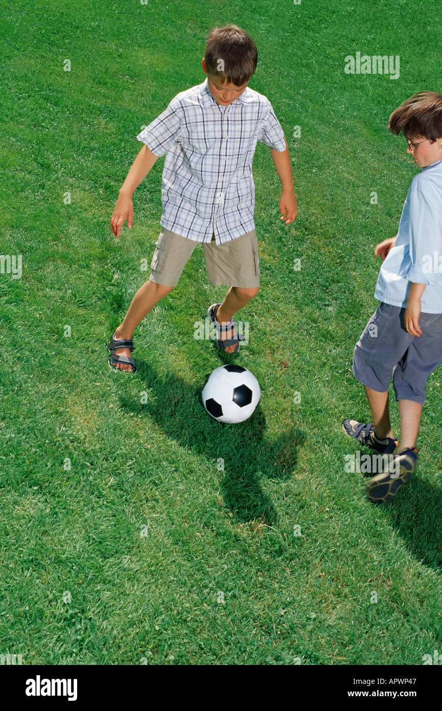 Boys playing football Stock Photo - Alamy