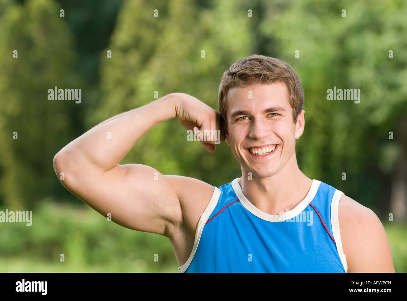 portrait of young man showing his bicep Stock Photo - Alamy
