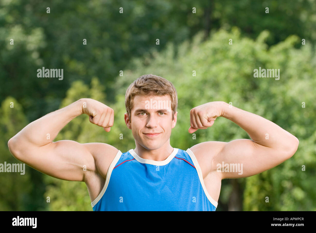 portrait of young man showing his biceps Stock Photo - Alamy