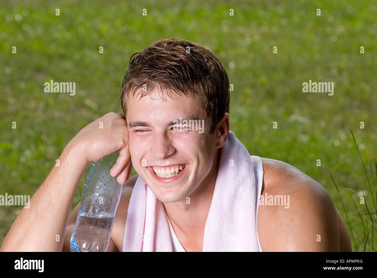 portrait of smiling young man holding water bottle Stock Photo - Alamy