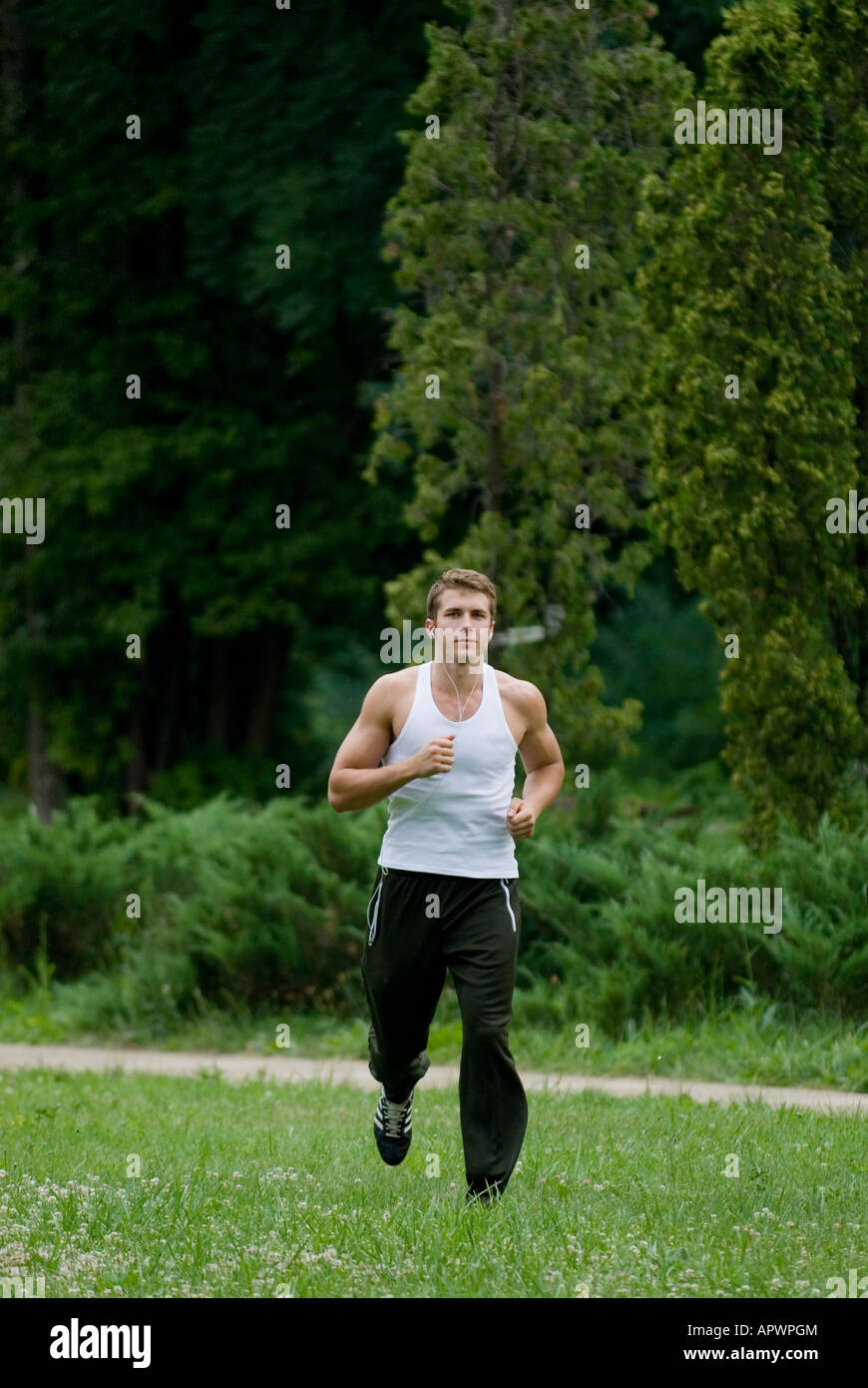 young man jogging through park Stock Photo - Alamy
