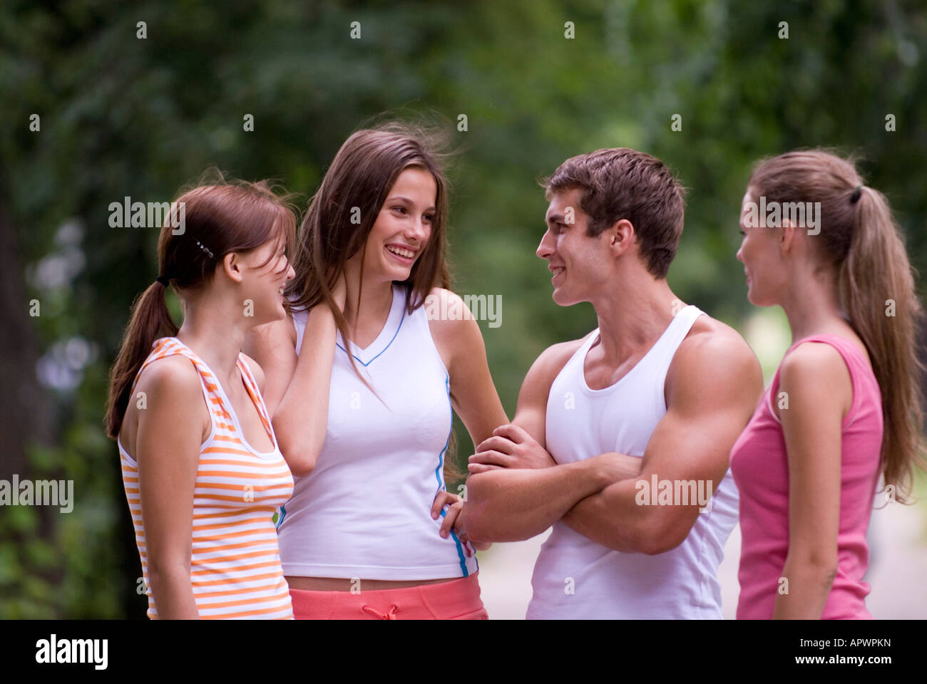 three young woman admiring sporty young man Stock Photo - Alamy