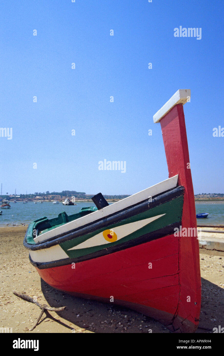 Red Fishing Boat on beach, Alvor Harbour, Algarve, Portugal Stock Photo ...