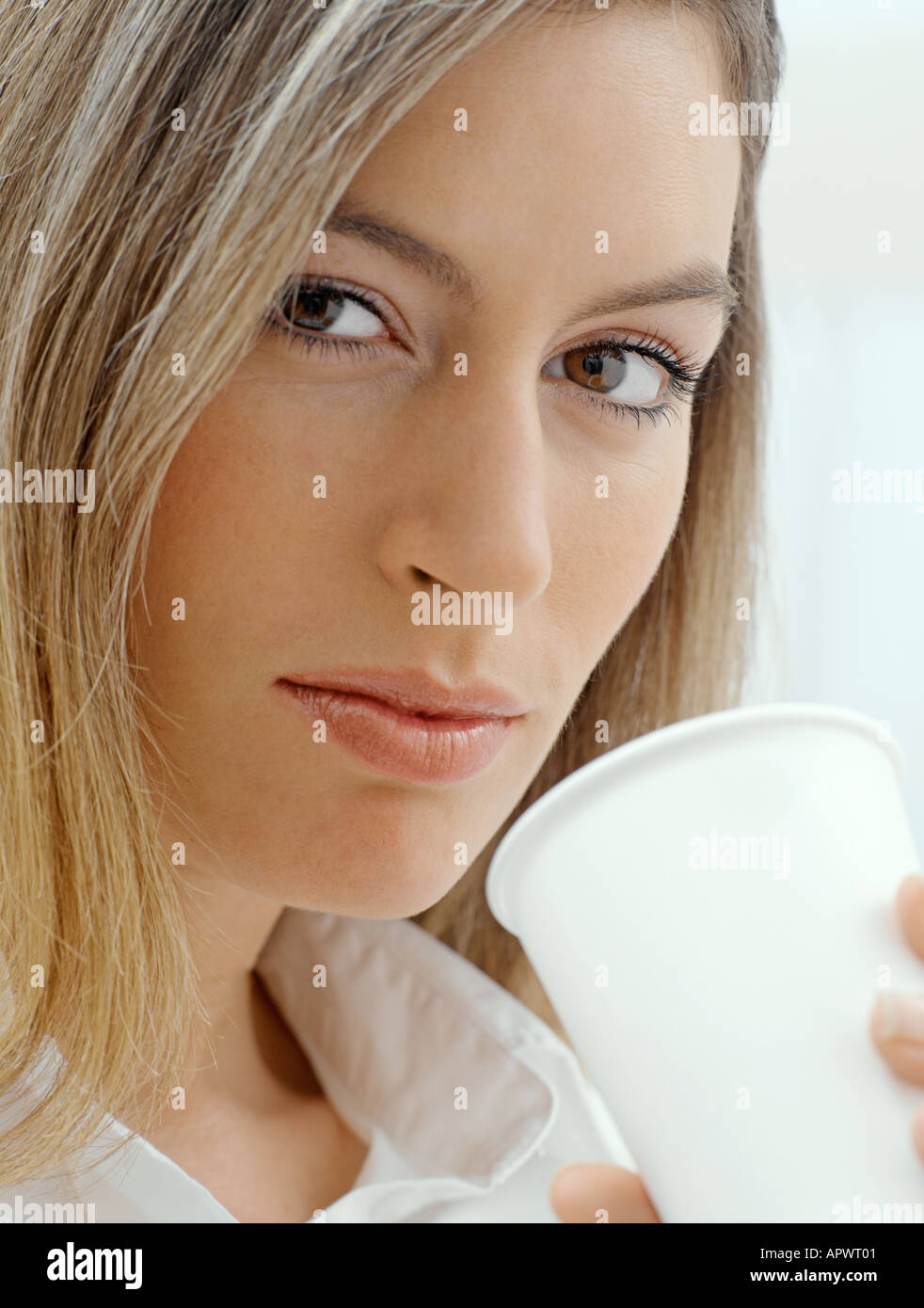 Woman holding a plastic cup Stock Photo - Alamy