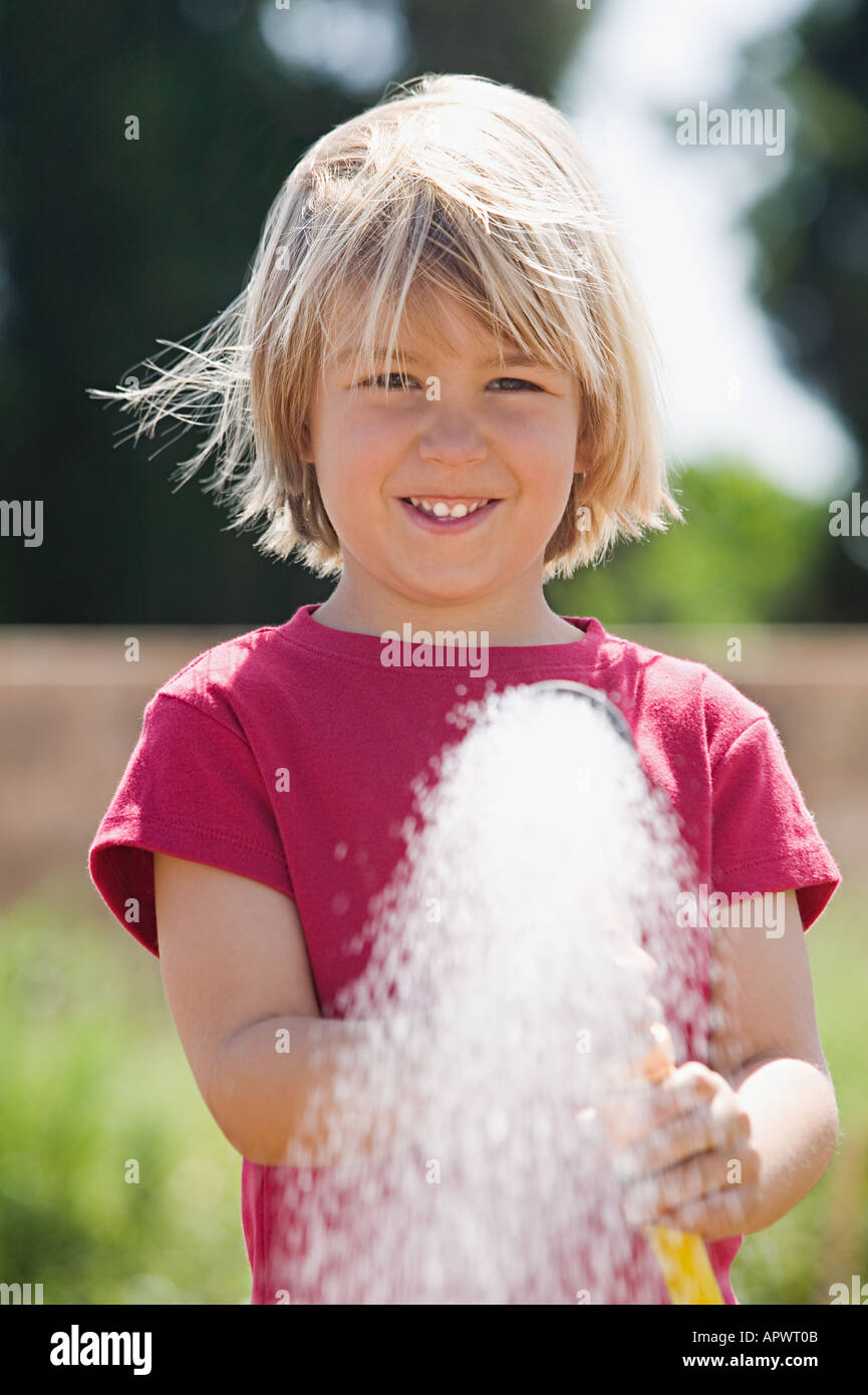 Boy spraying water Stock Photo - Alamy