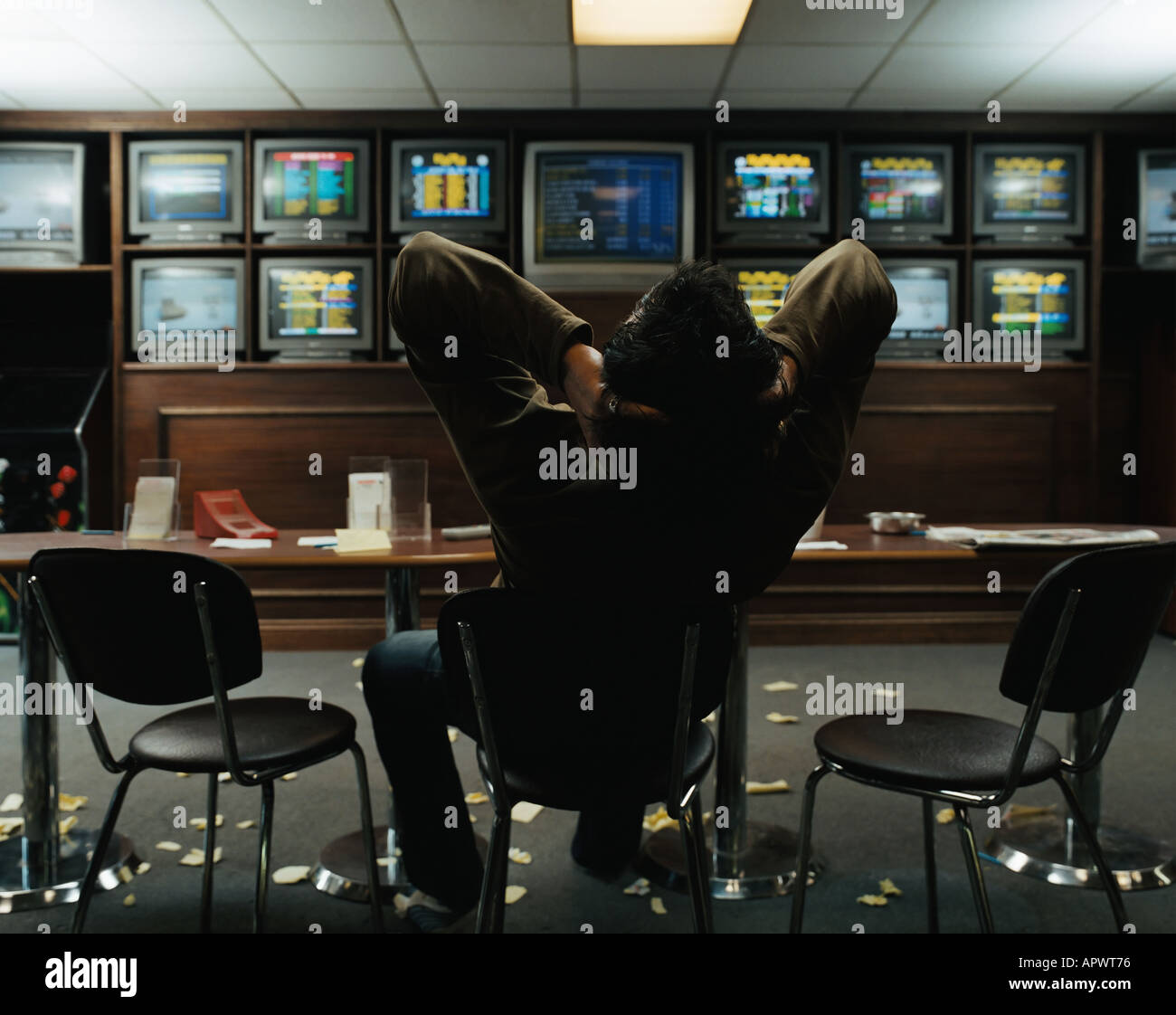 Man sitting in a betting shop Stock Photo - Alamy
